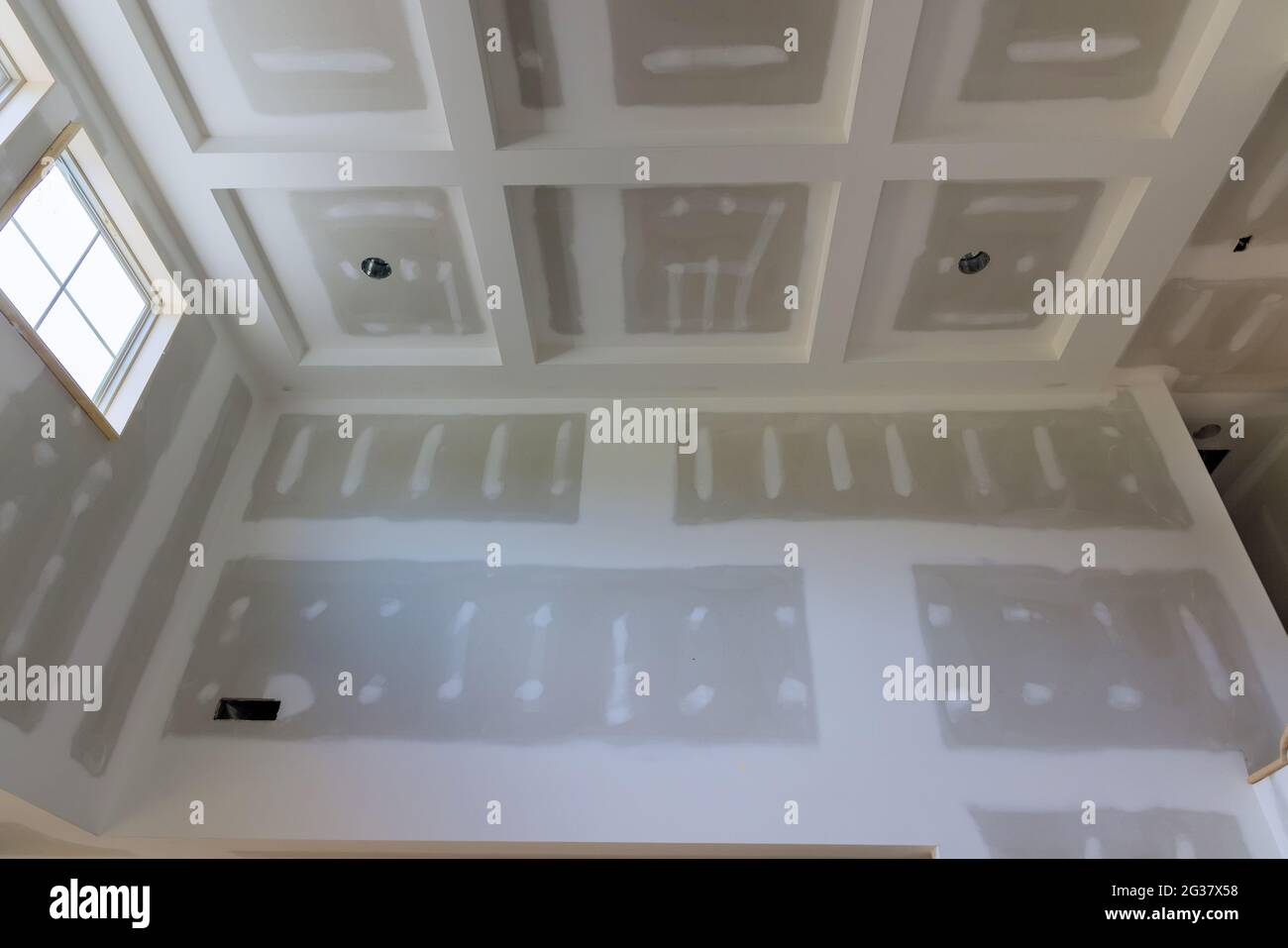 Finishing putty on drywall with a spatula the house on ceiling and wall ...