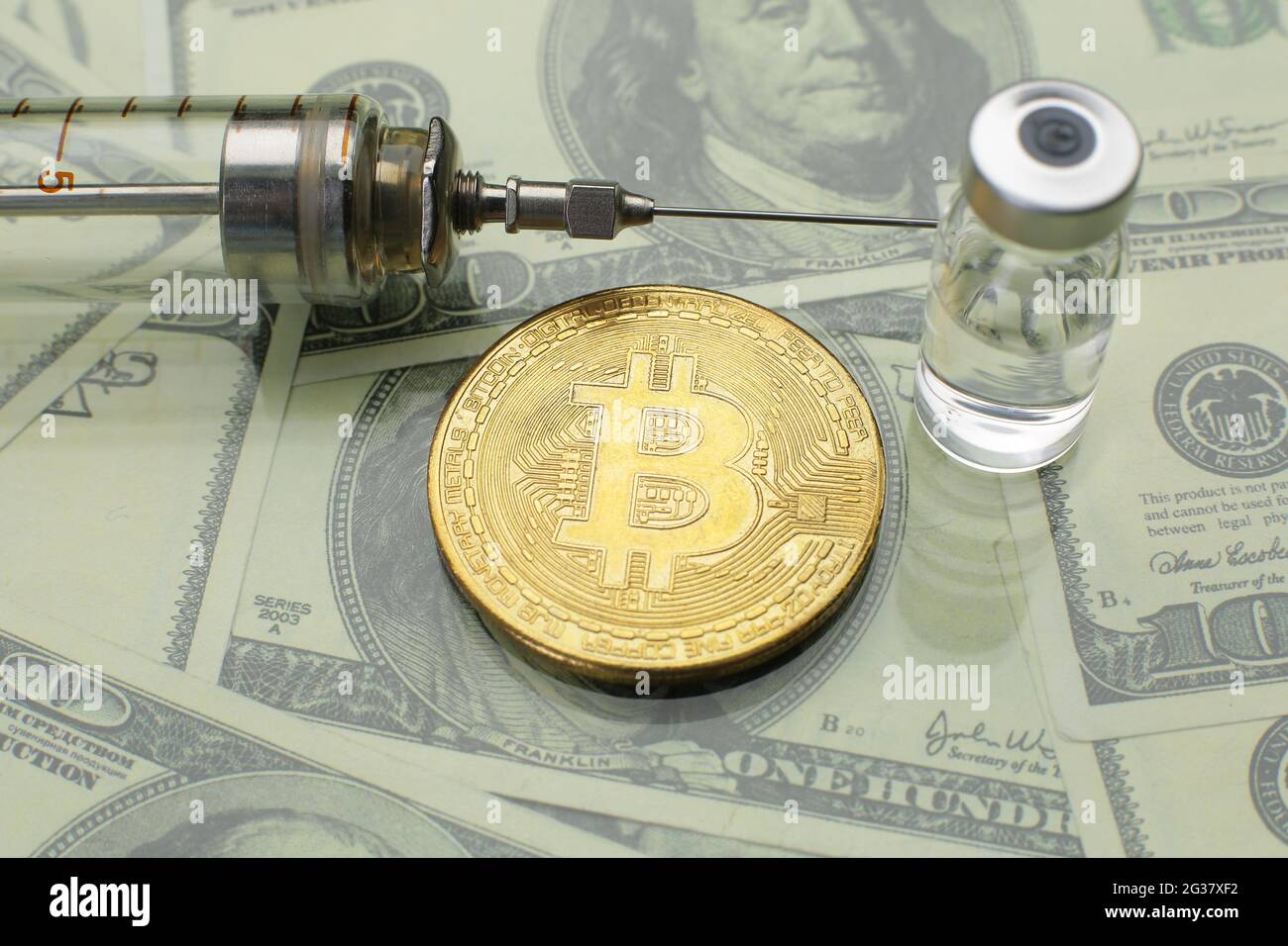 Bitcoin glass syringe and medical vaccine vial on american dollars ...