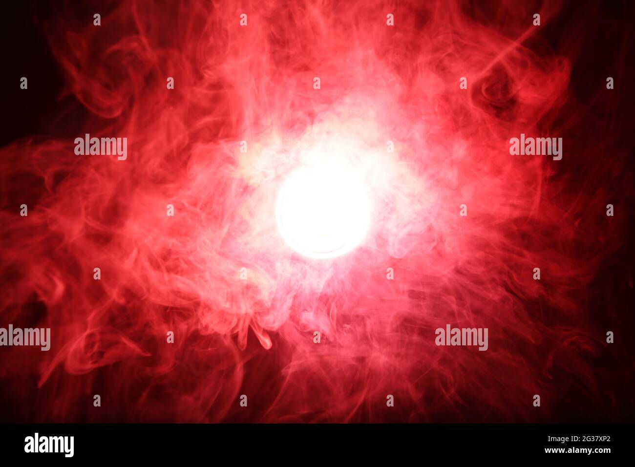 Smoke in red light on black background Stock Photo - Alamy