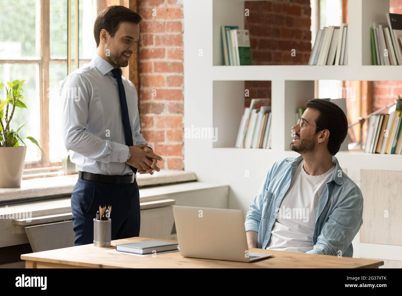 Happy friendly colleagues communicating in modern office room Stock ...