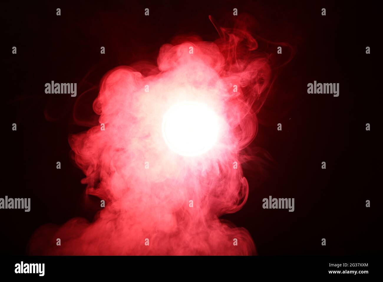 Smoke in red light on black background Stock Photo - Alamy
