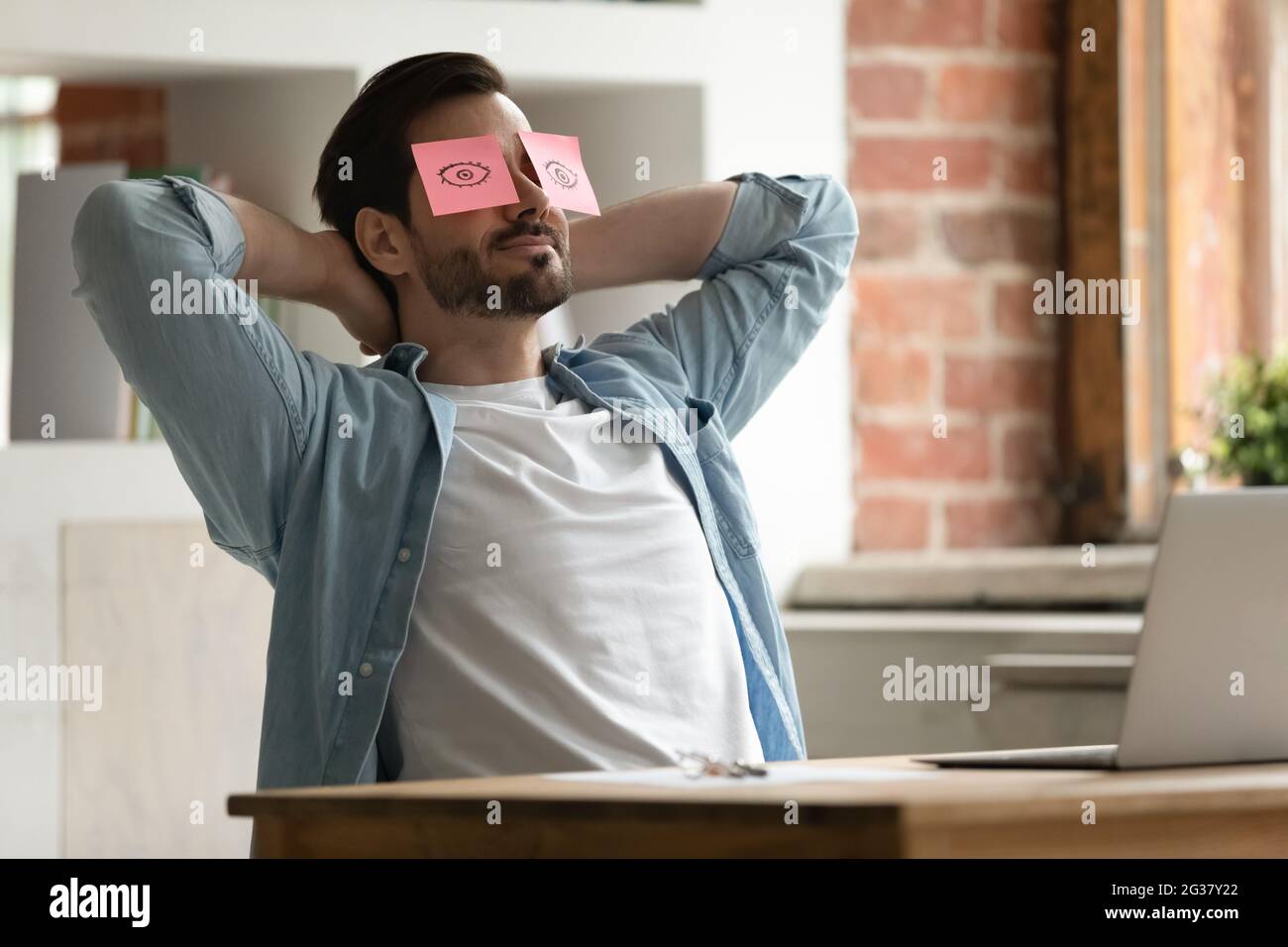 Peaceful young man relaxing with sticky paper notes on eyes Stock Photo ...