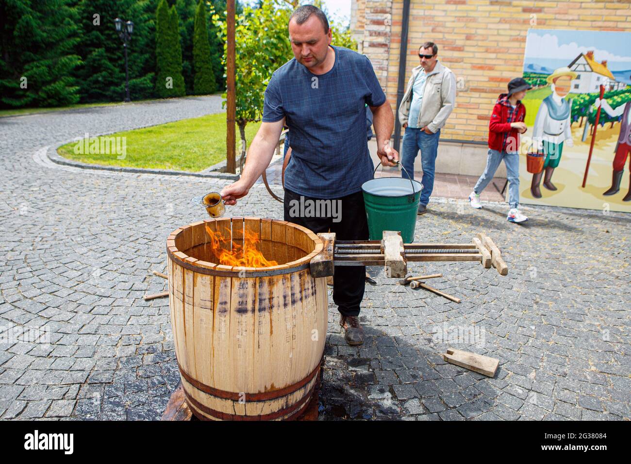 BEREHOVE, UKRAINE - JUNE 13, 2021 - A man makes a wine barrel during ...
