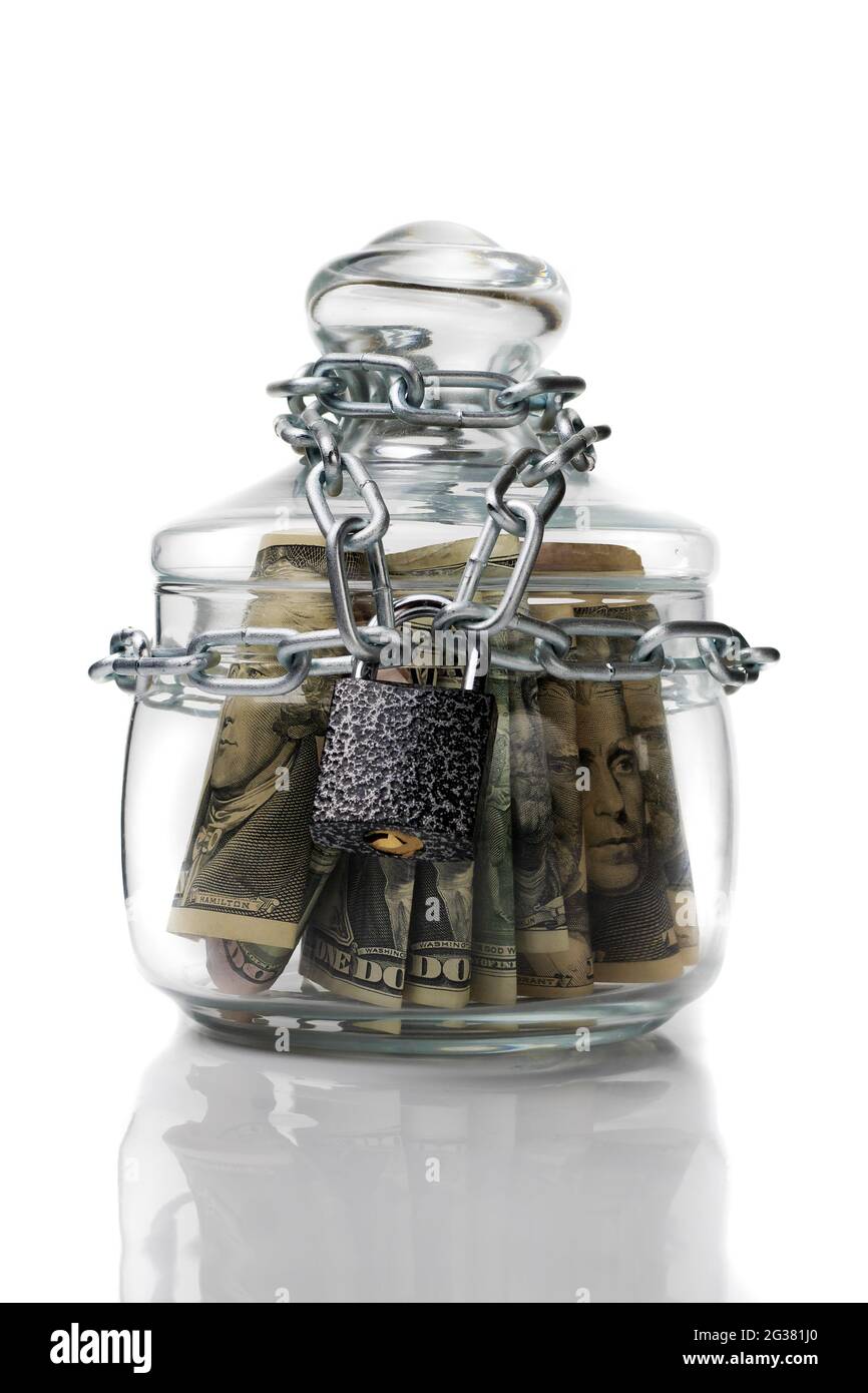 dollar banknotes on glass jar locked with padlock and chain isolated on ...