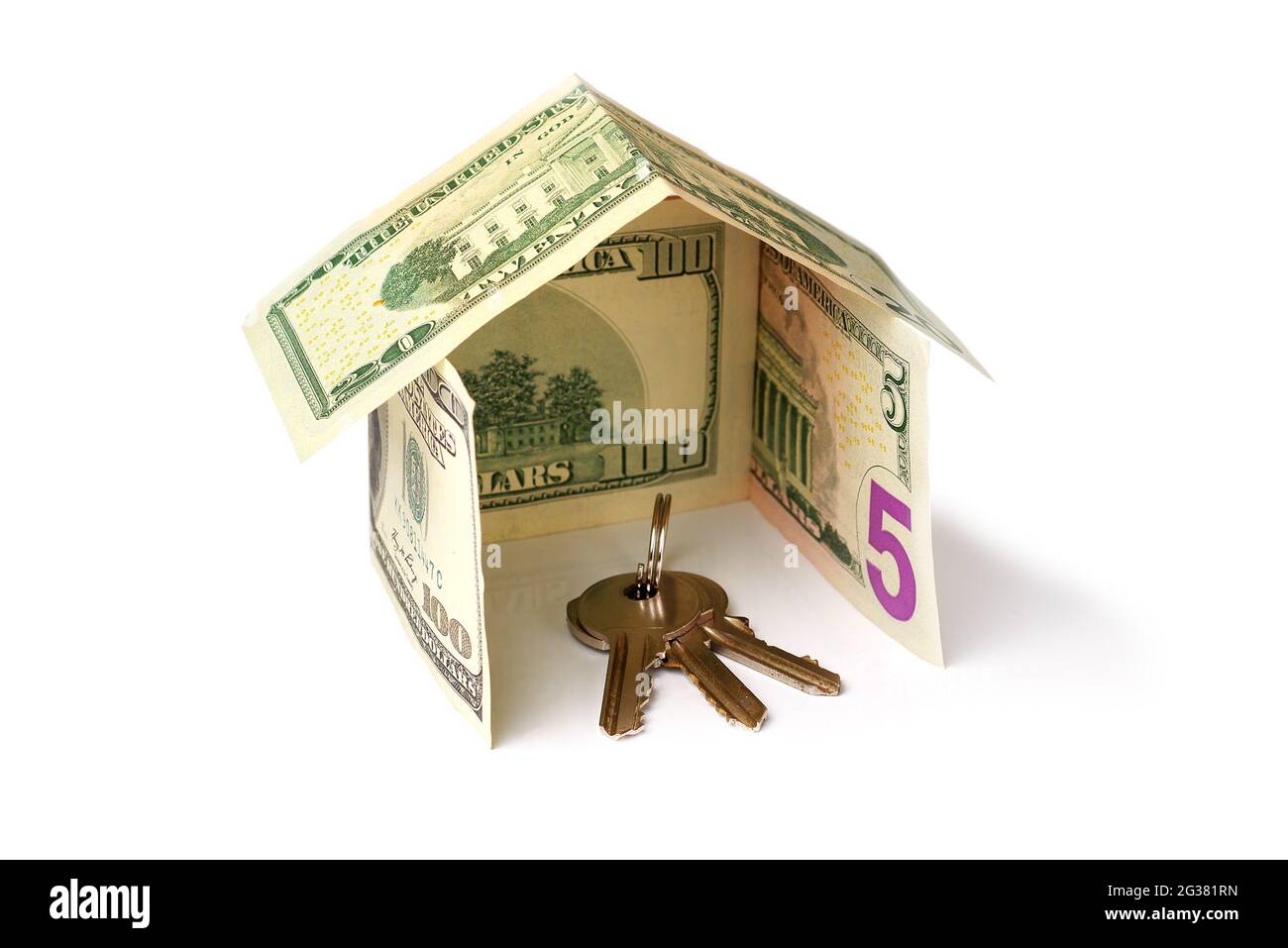 bunch of keys inside a house made from dollar banknotes on white ...