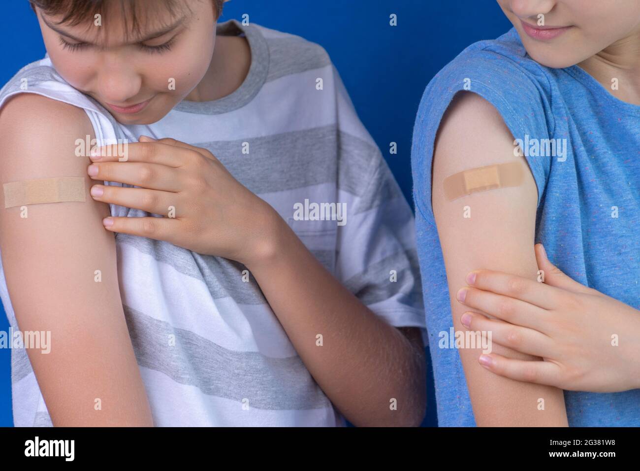 Boys with adhesive bandage plaster on their arms after vaccination ...