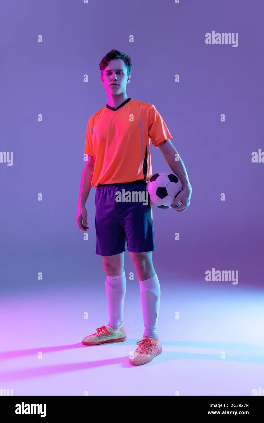 Full-length portrait of professional football player standing isolated ...