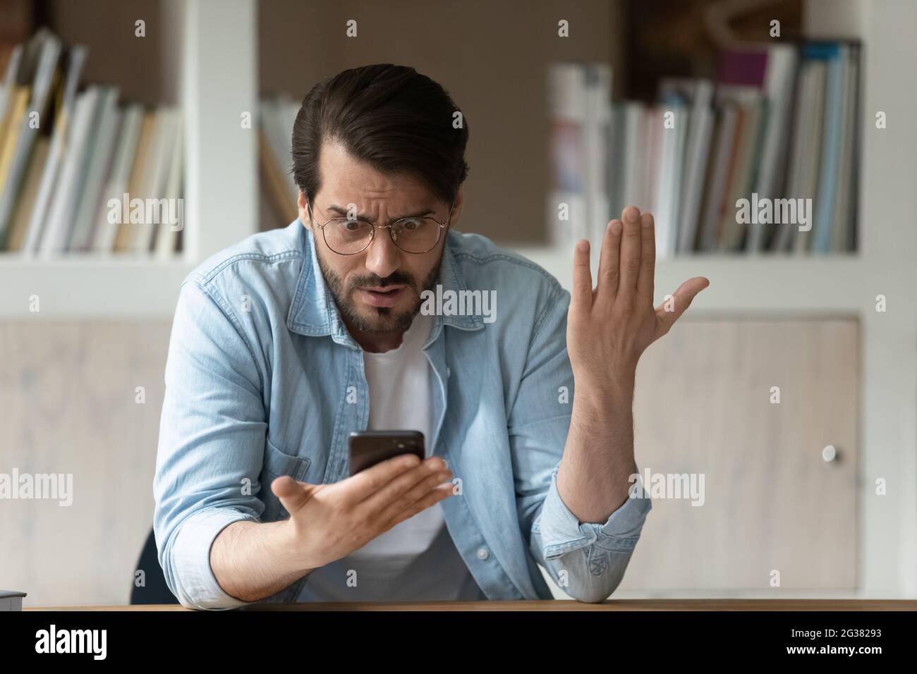 Angry nervous young man dissatisfied with bad device work Stock Photo ...