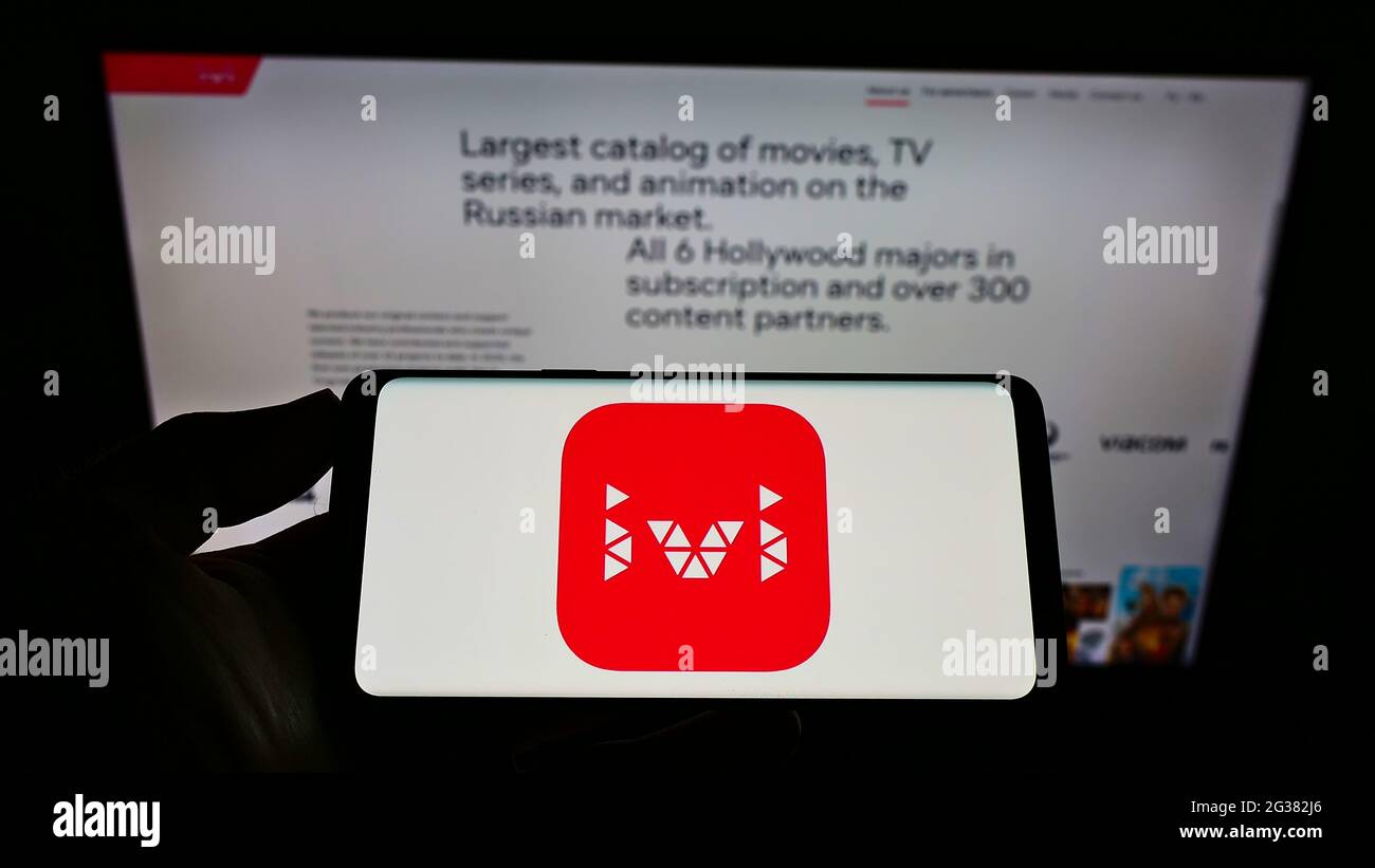 Person holding cellphone with logo of Russian video streaming platform ...