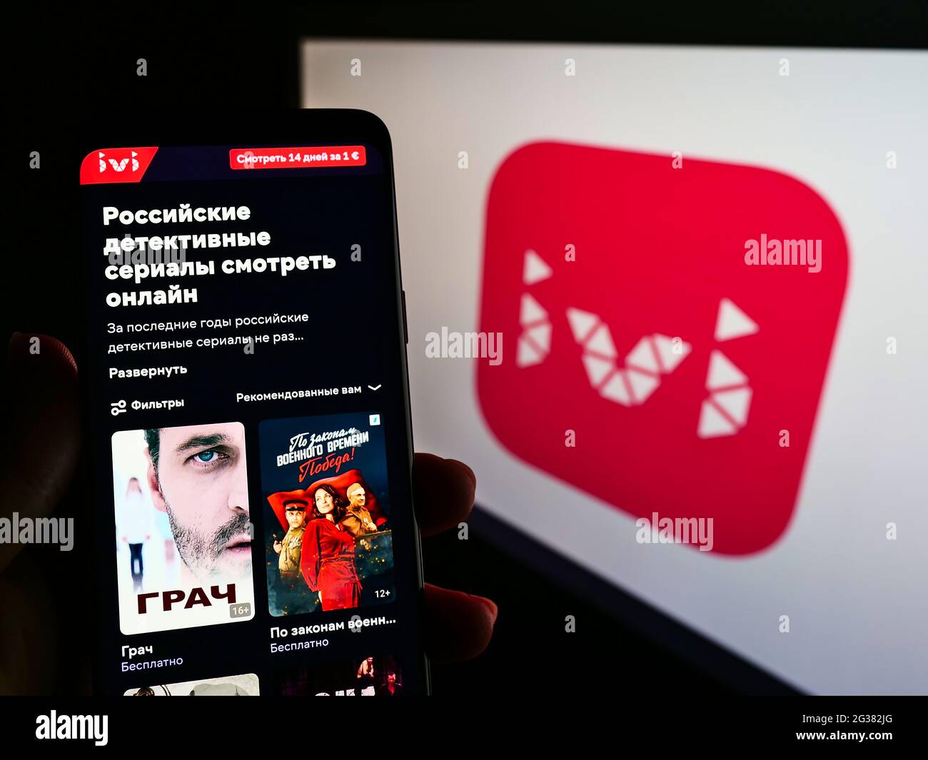 Person holding smartphone with website of Russian video streaming platform ivi (ivi.ru) on ...