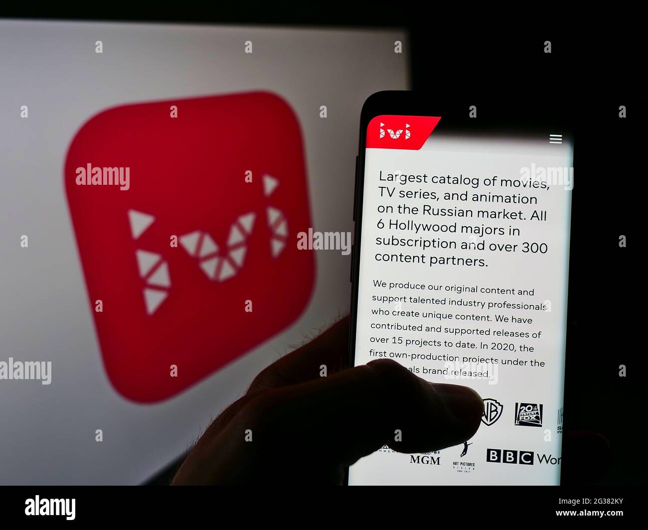 Person holding cellphone with website of Russian video streaming ...