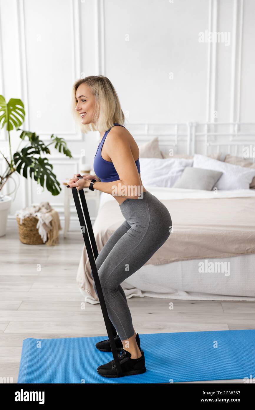 Young athletic attractive woman doing toning exercises for the muscles ...