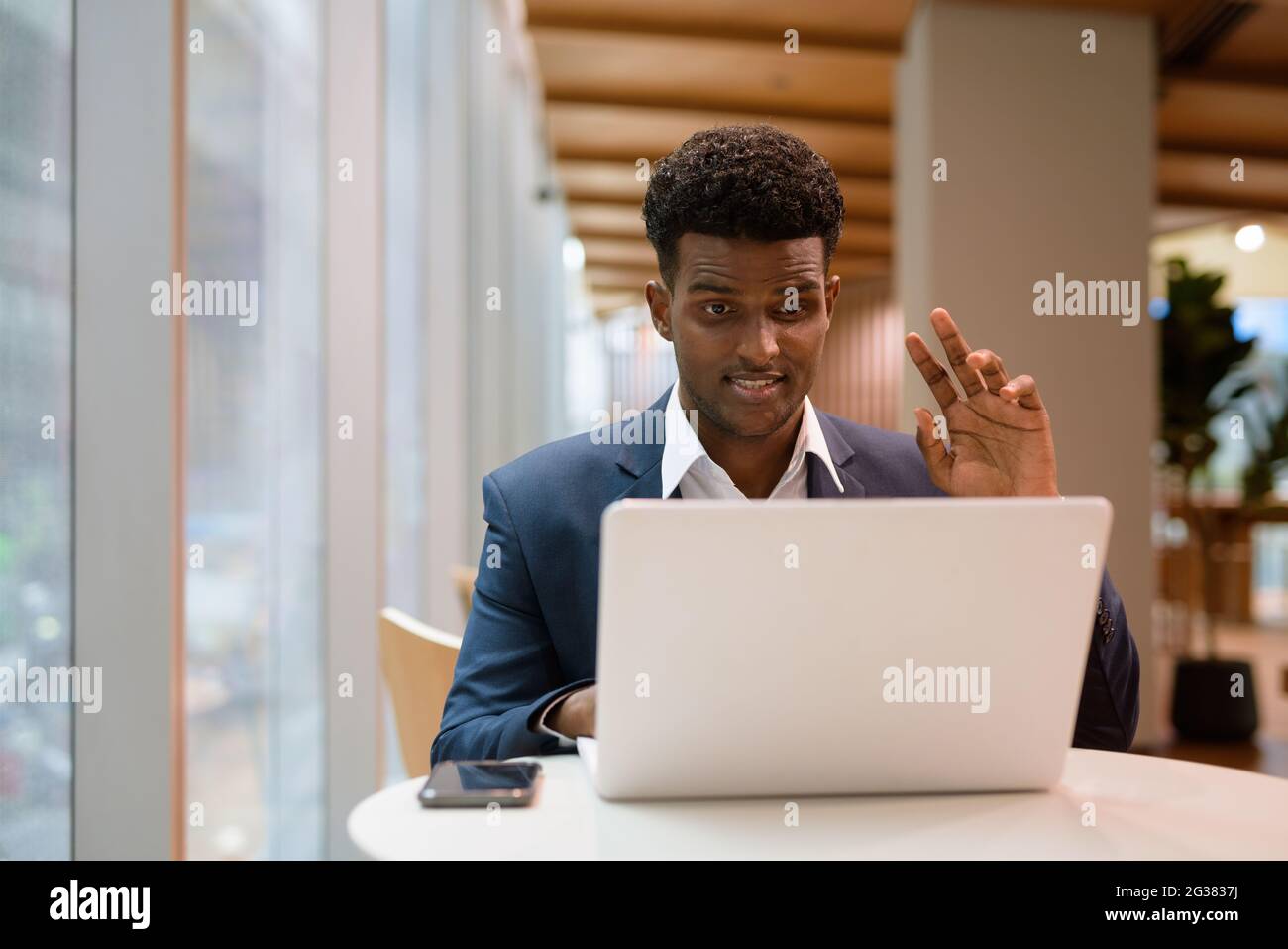 Man waving at computer hi-res stock photography and images - Alamy