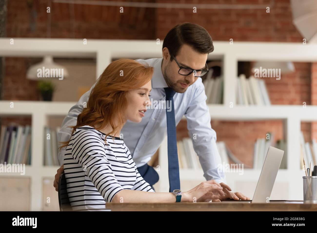 Male manager helping colleagues project hi-res stock photography and ...