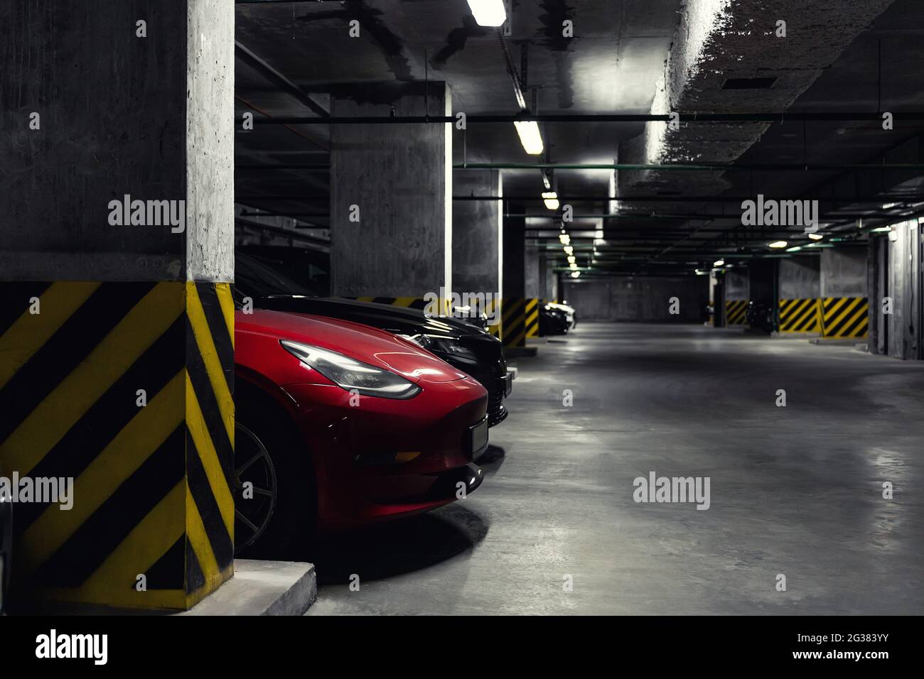 Dark scenic car park underground multilevel garage interior. Concrete ...