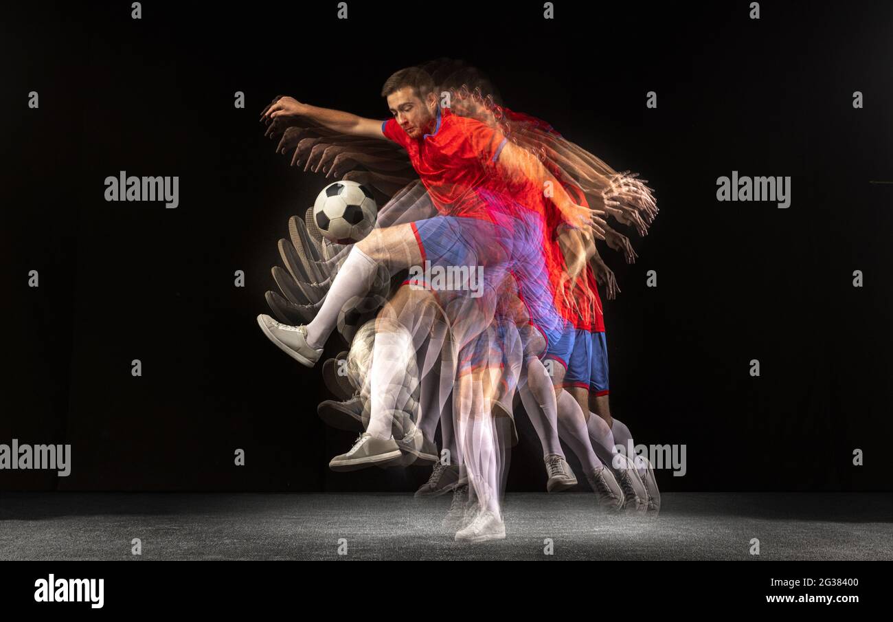 Non stop moving. Young caucasian football soccer player playing in ...