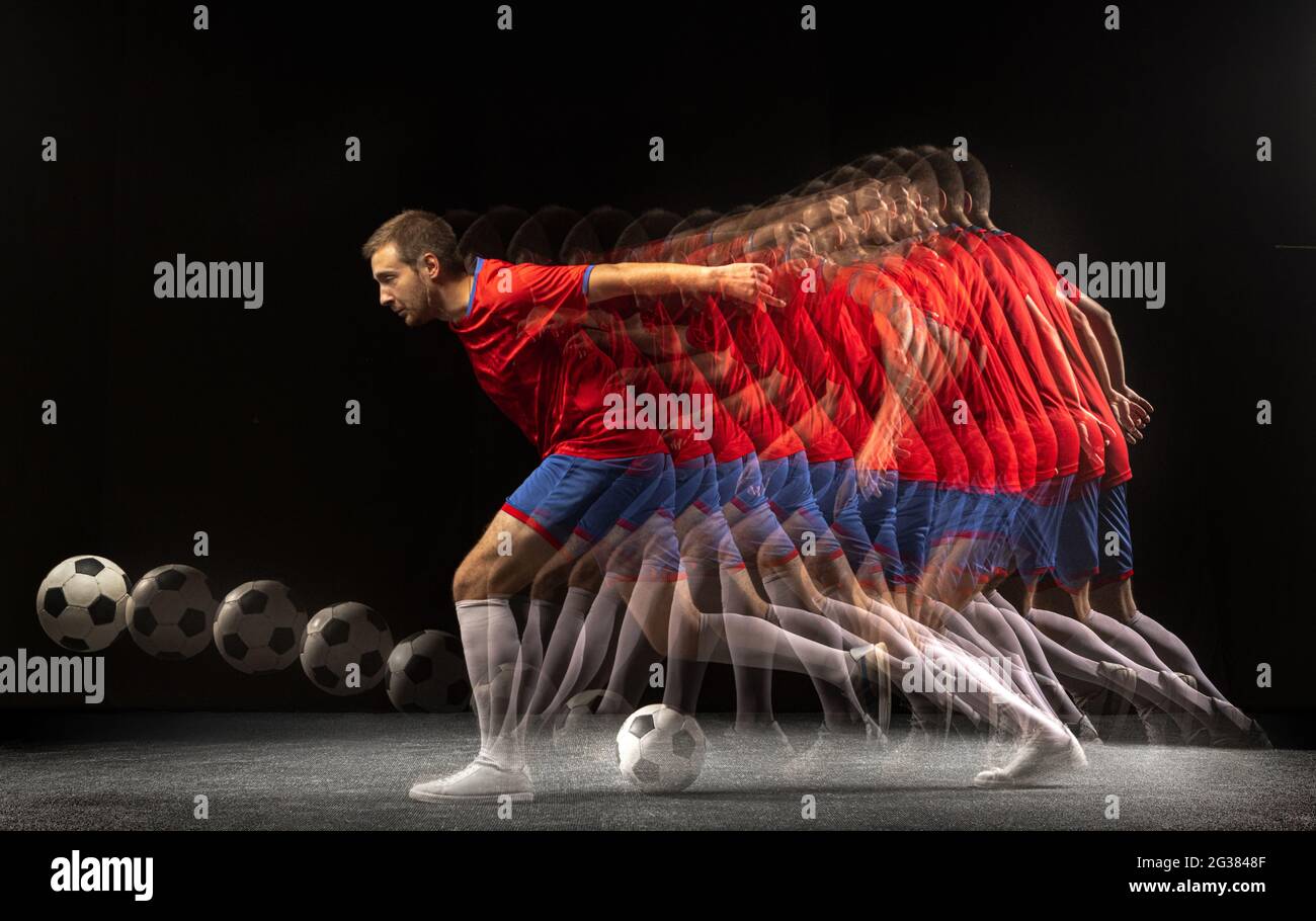 Non stop moving. Young caucasian football soccer player playing in ...