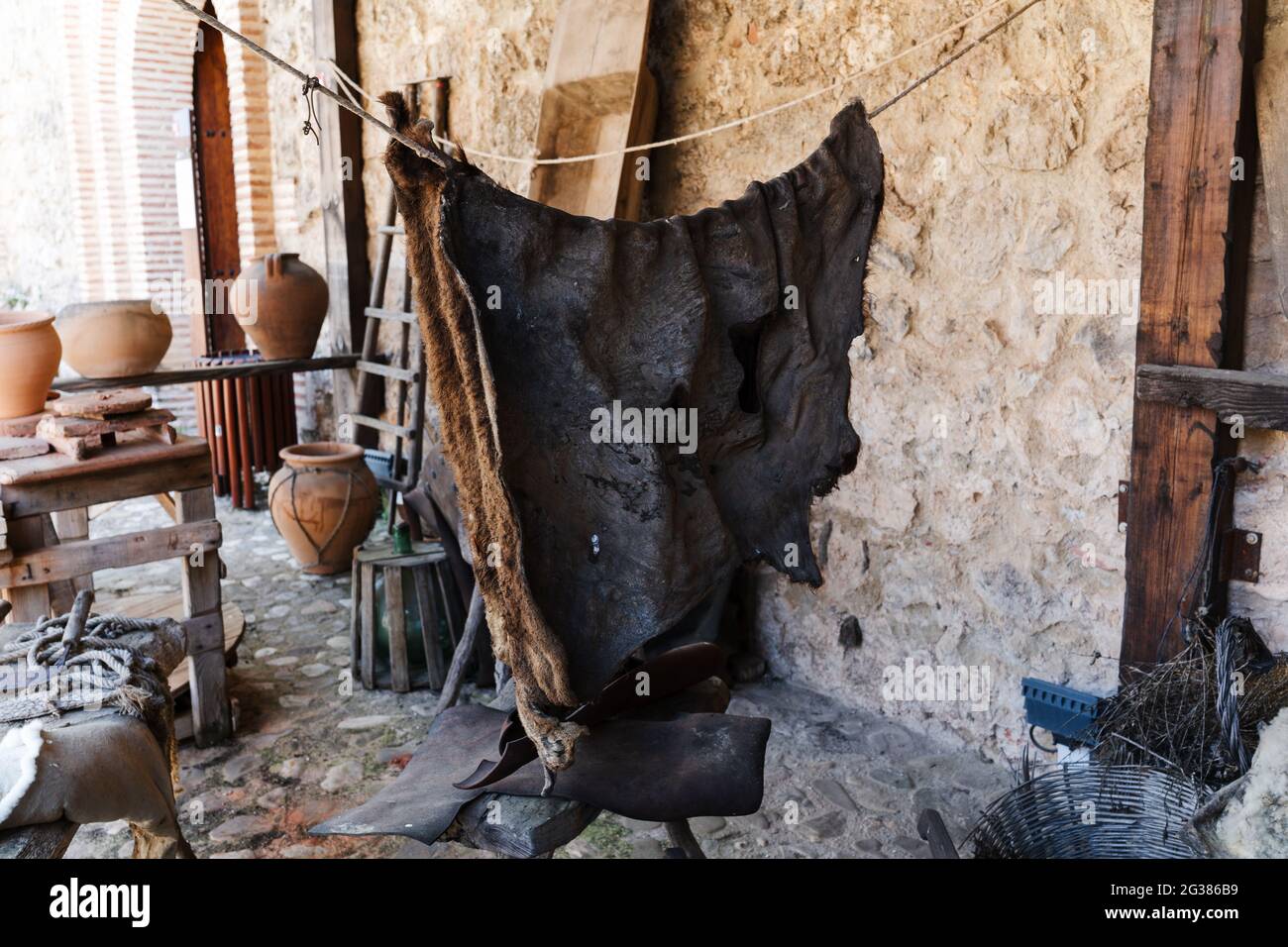 Old leather tanning hanging on a rope Stock Photo - Alamy