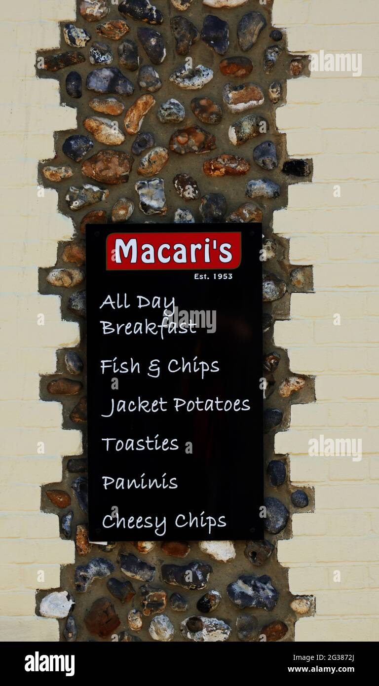 Sign and logo of Macaris restaurant seen on a wall Stock Photo - Alamy