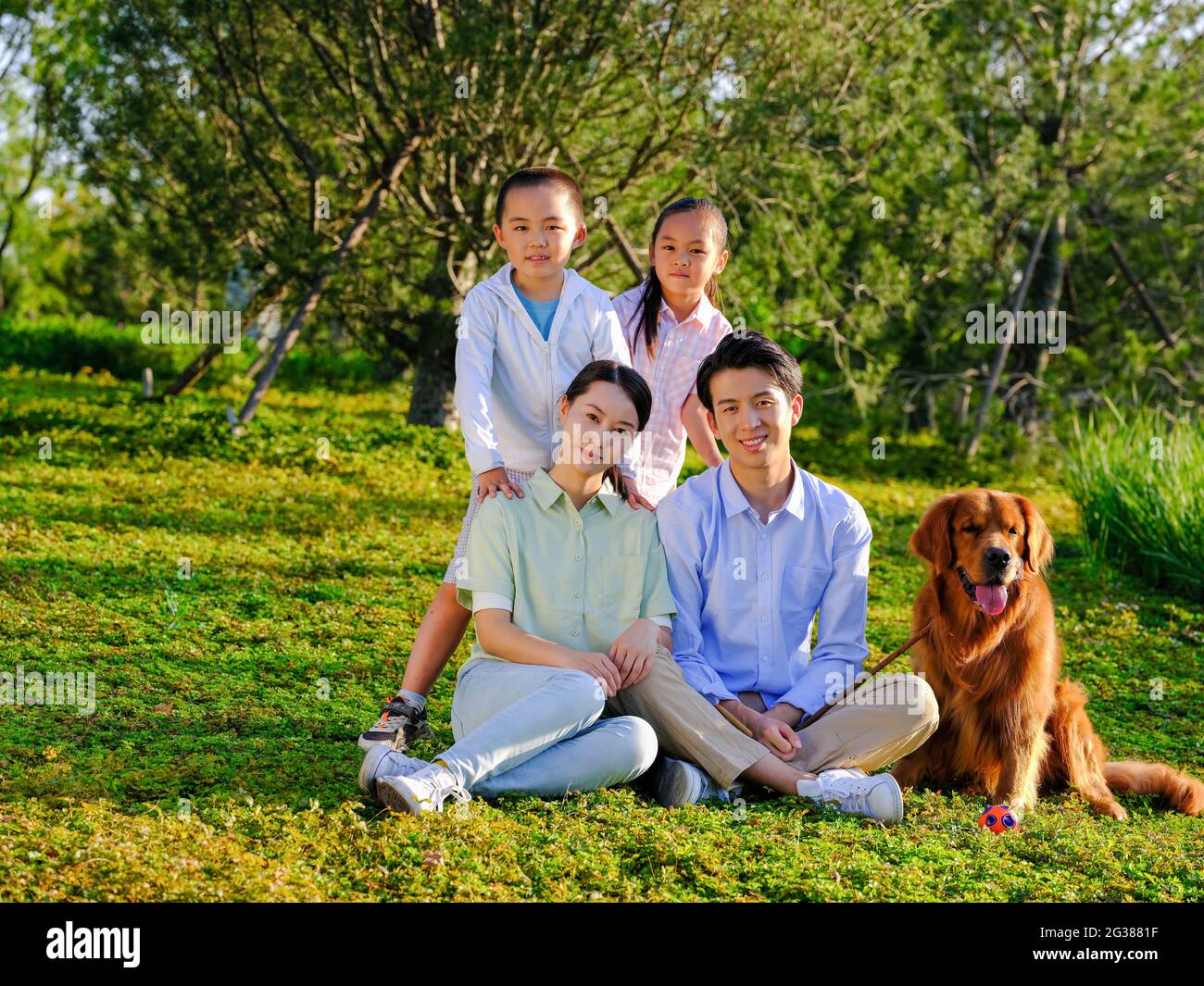 Happy family of four and pet dog in the park high quality photo Stock ...