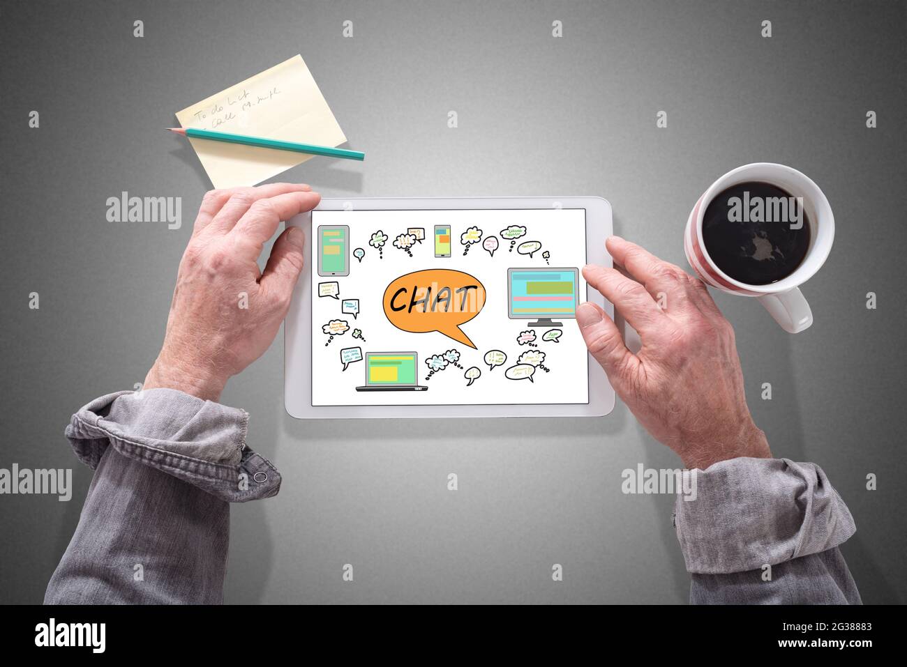 Male hands using a tablet showing chat concept Stock Photo - Alamy