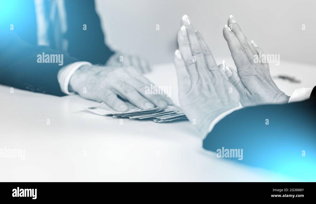 Woman refusing to take bribe Stock Photo - Alamy