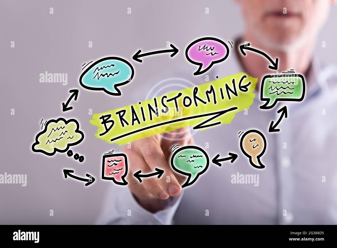 Man touching a brainstorming concept on a touch screen with his finger ...