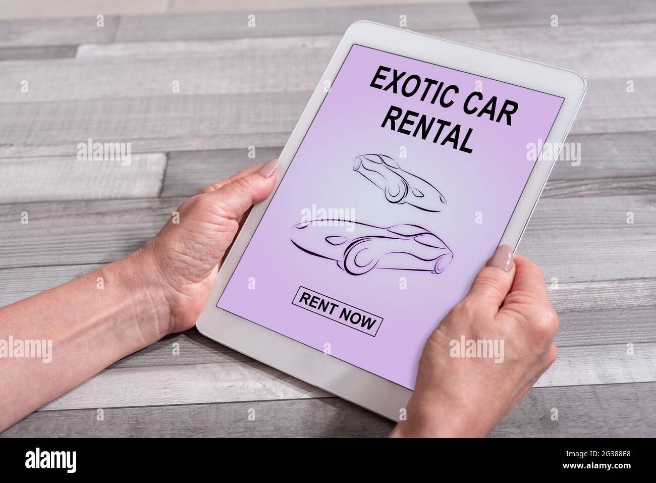 Female hands holding a tablet with exotic car rental concept Stock ...