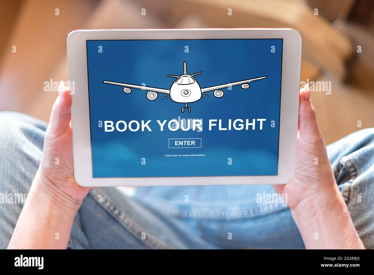 Tablet screen displaying a flight booking concept Stock Photo - Alamy