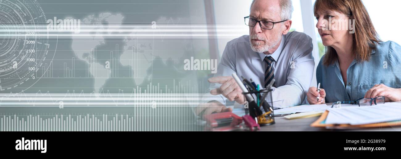 Two mature business people working together in office. panoramic banner ...