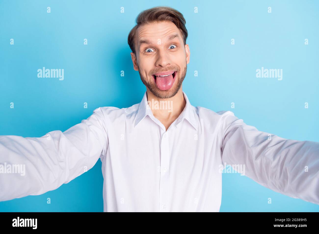 Photo of funky happy crazy young man take selfie make funny face ...