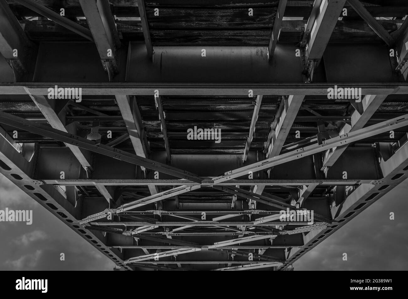 view of a structure of gray metal railway bridge for train, down to up ...