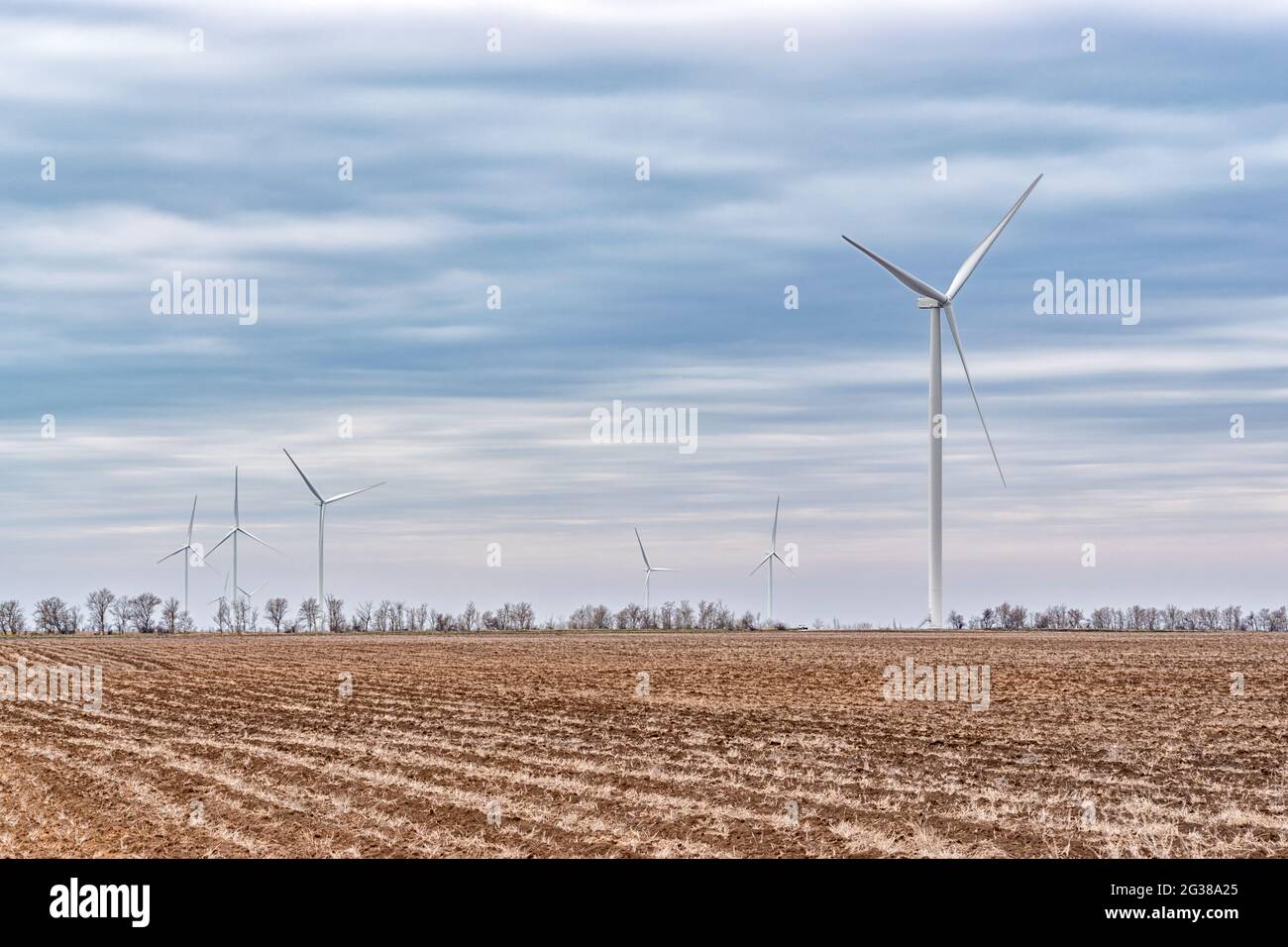 Wind turbines generating electricity in a field. Green power generation ...