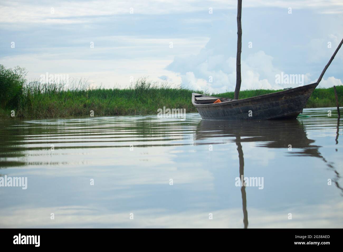A small wooden boat in the middle of the river. The amazing beauty of ...