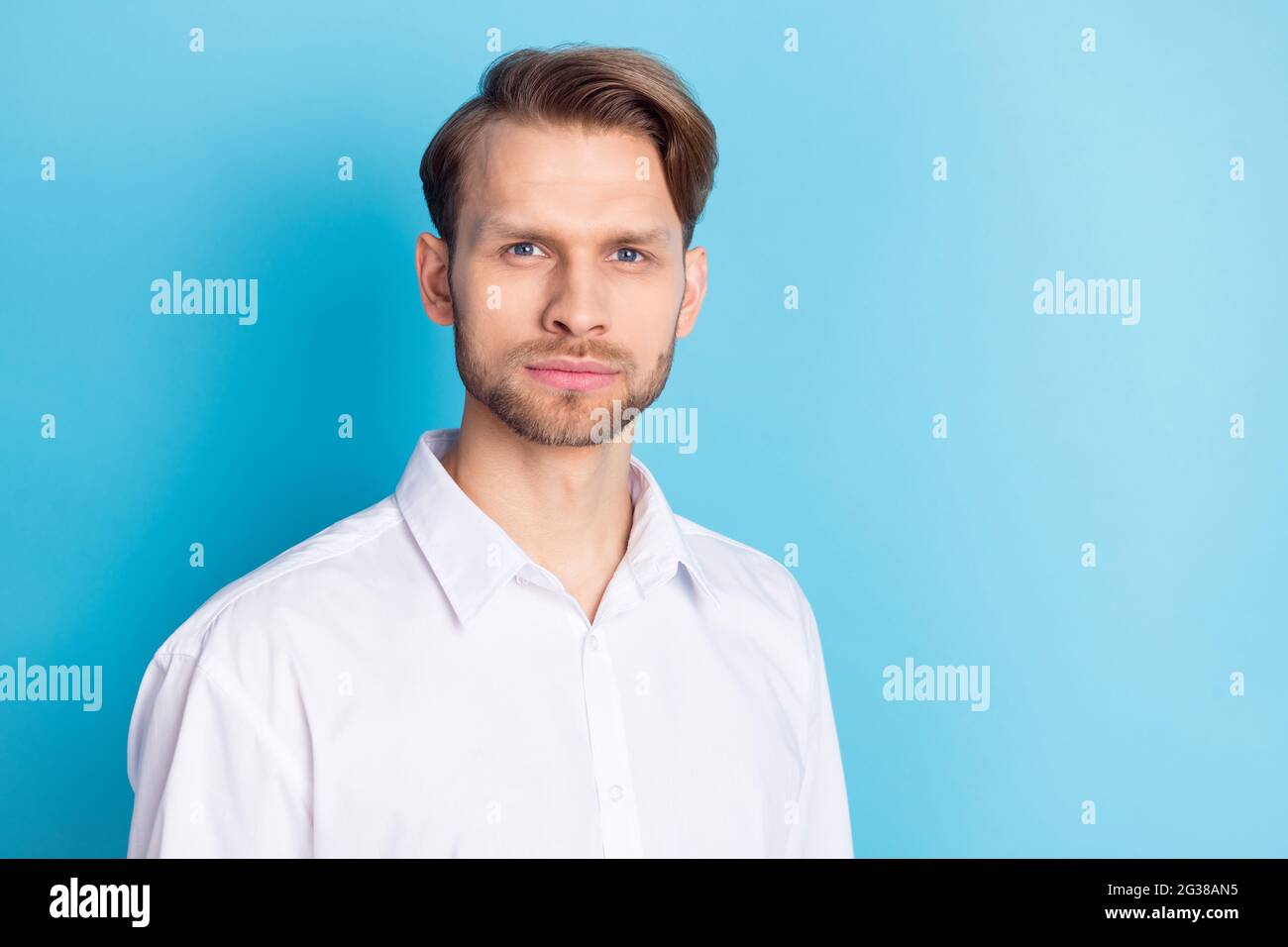 Photo of serious young calm man businessman wear white shirt isolated ...