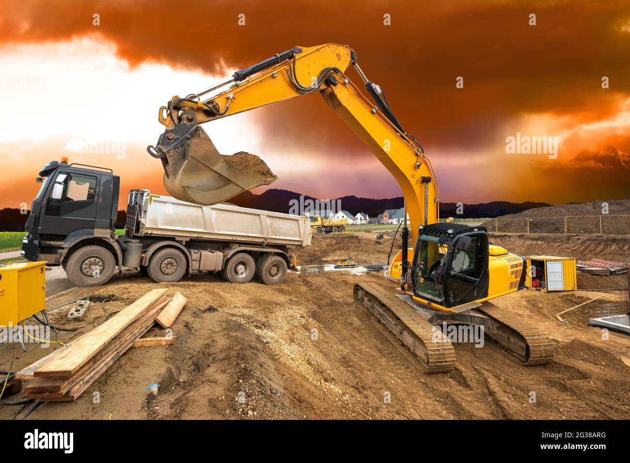 earth mover and excavator at work in construction site Stock Photo - Alamy