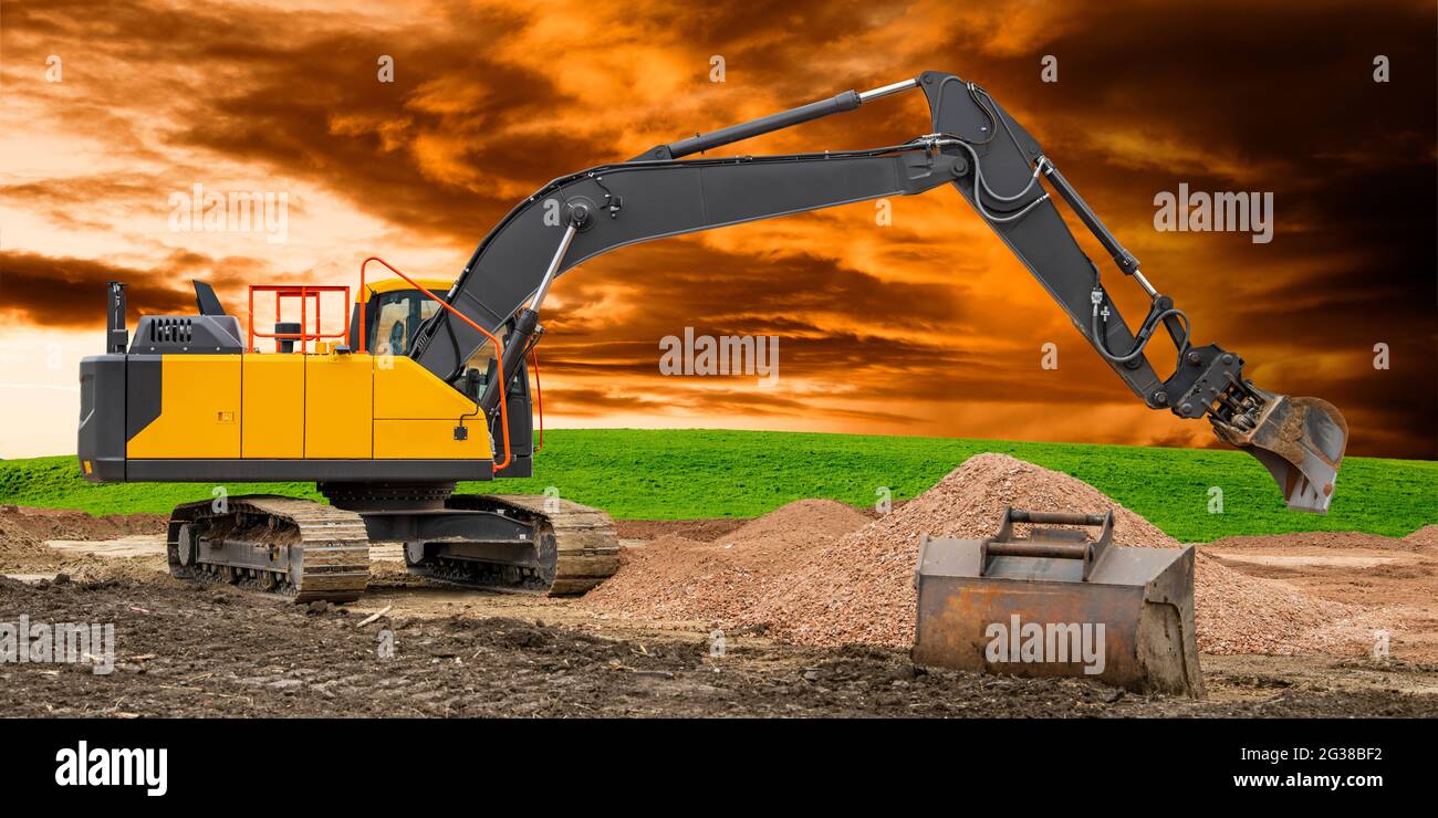 earth mover and excavator at work in construction site Stock Photo - Alamy