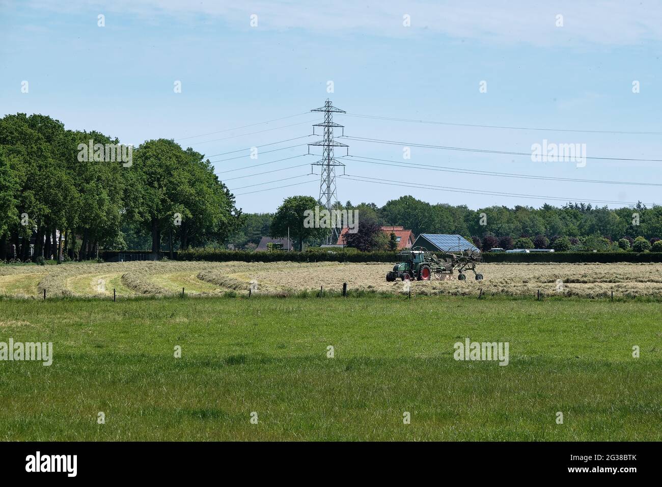 Dronten, the Netherlands June1,2021:Grassland with tractor mower and ...