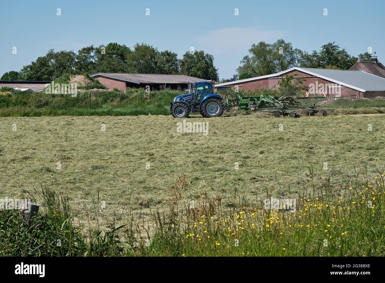 Dronten, the Netherlands June1,2021:Grassland with big tractor mower ...