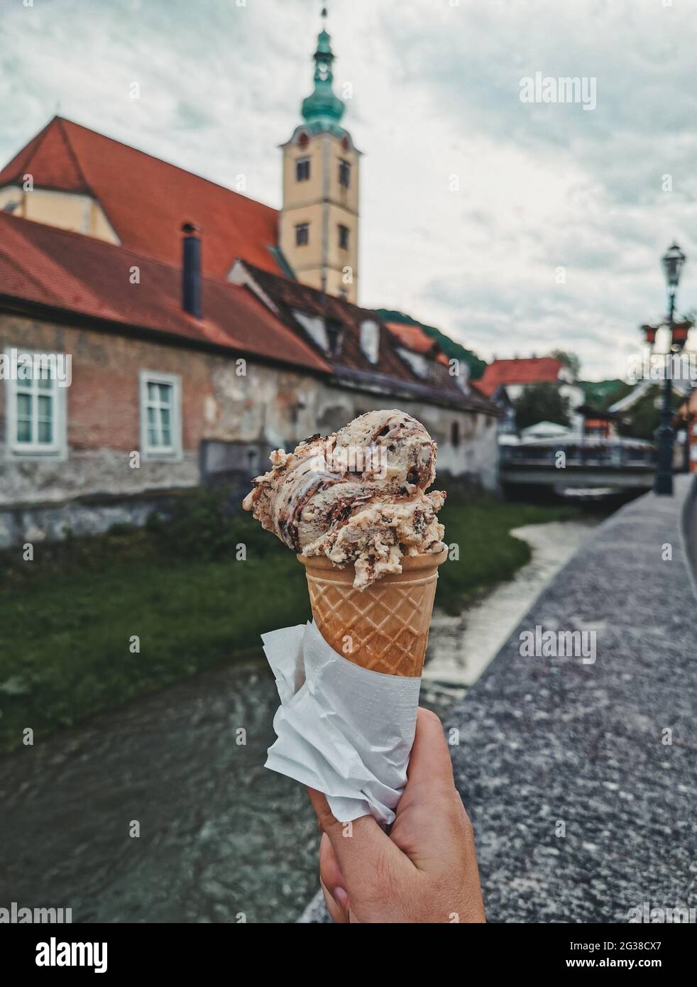 Personal perspective of hand holding ice cream in cone in city Stock ...