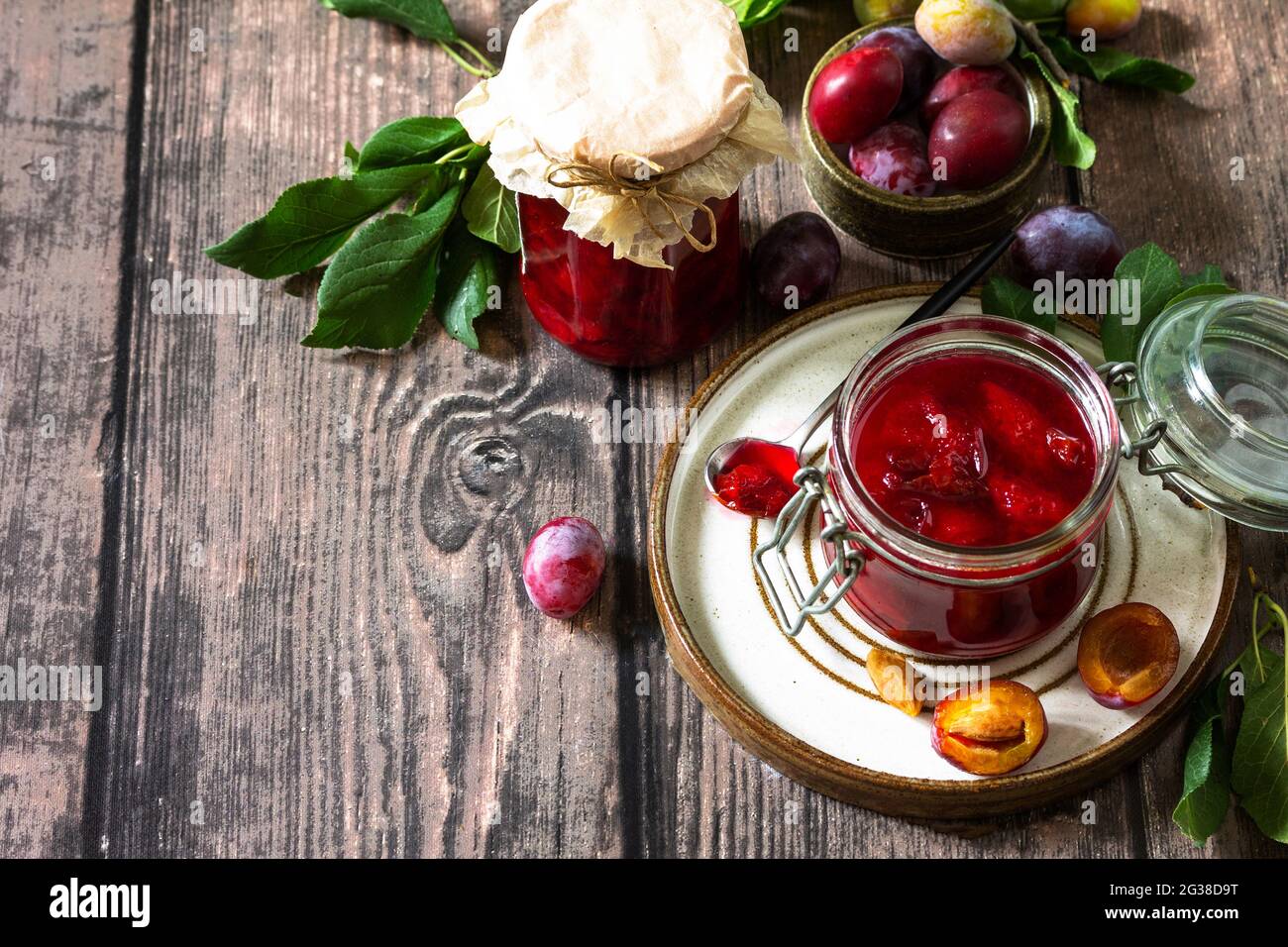 Homemade preservation. Delicious plum jam on a rustic wooden table ...