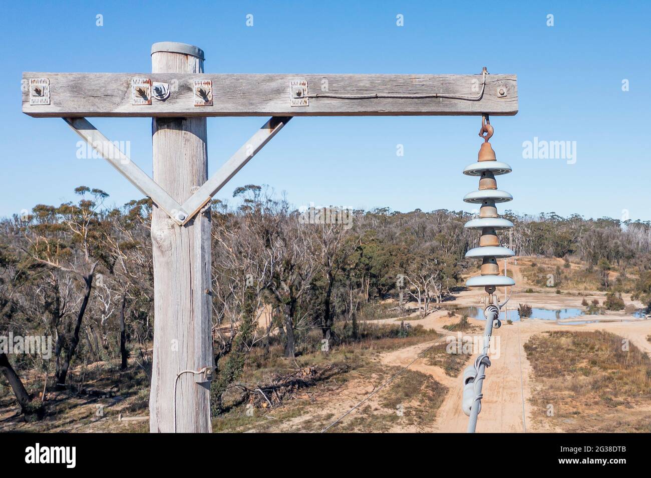 Drone aerial photograph of a telephone pole and wires in a forest ...