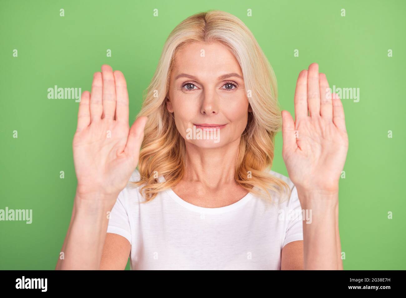 Photo of cute blond elder lady show stop sign wear white t-shirt ...