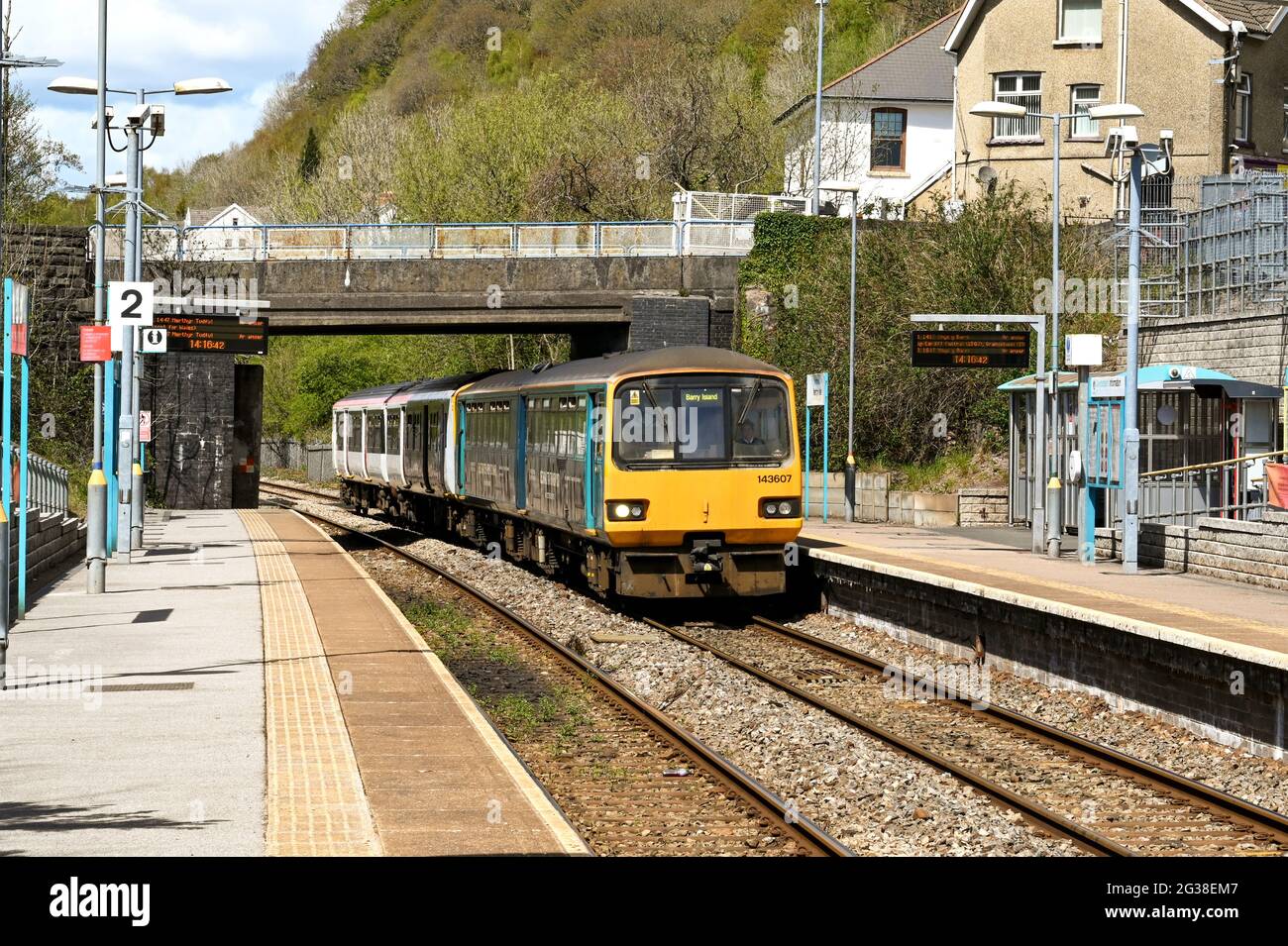 Merthyr Tydfil, Wales - May 2021: Commuter train arriving at Merthyr Vale railway station in ...