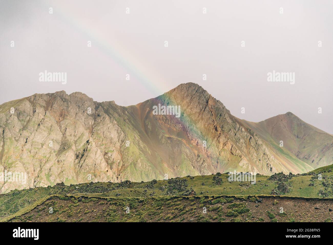 Rainbow in the mountains. A natural phenomenon Stock Photo - Alamy