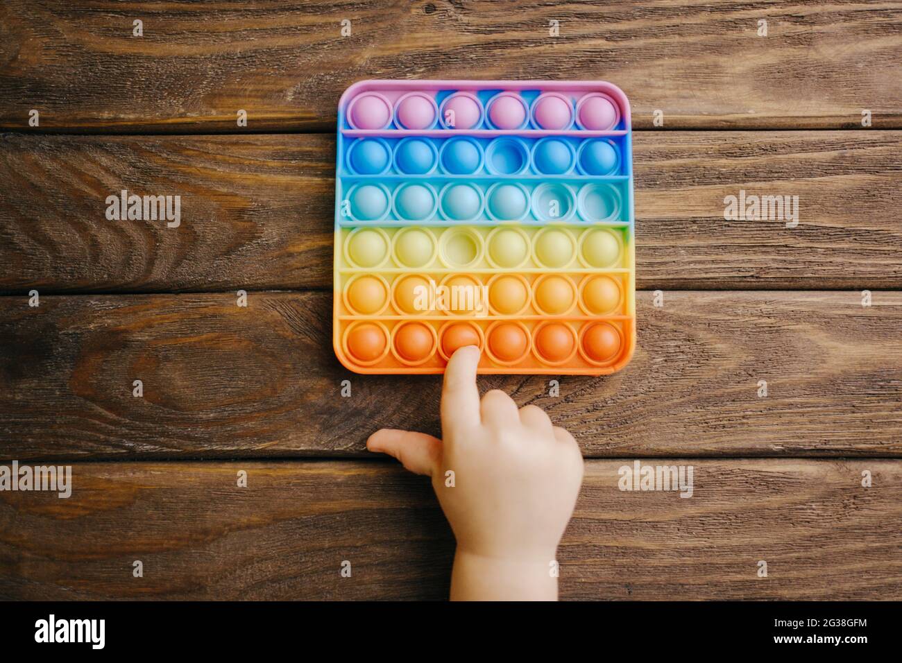 The child plays with the popular 'simple dimple' toy Stock Photo - Alamy