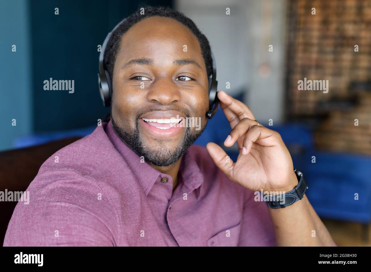 Hilarious African man using wireless headset for connection with ...