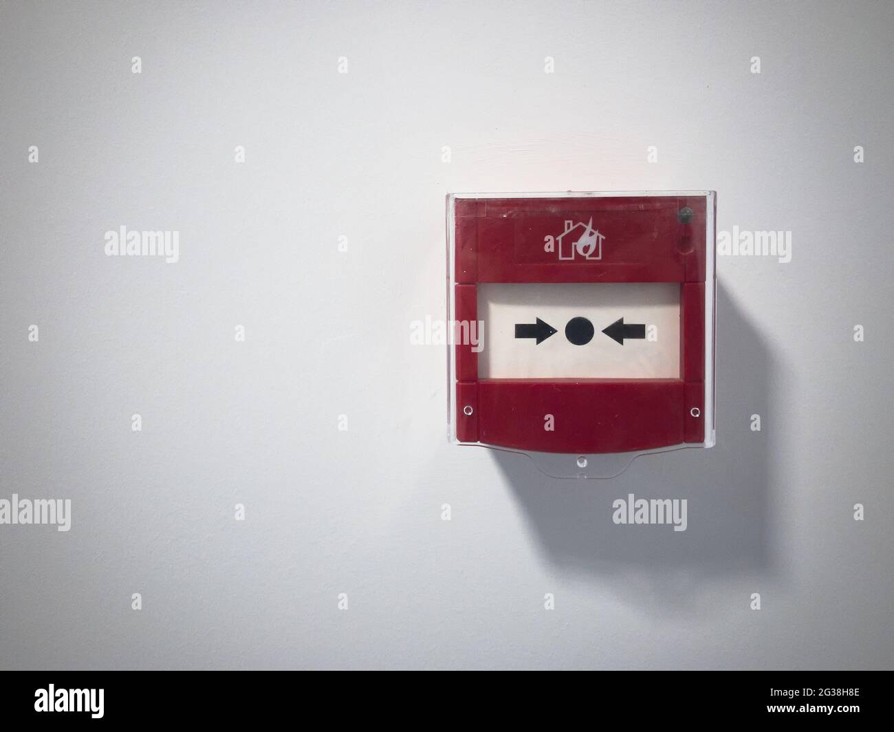Red fire alarm button against blank white wall Stock Photo - Alamy