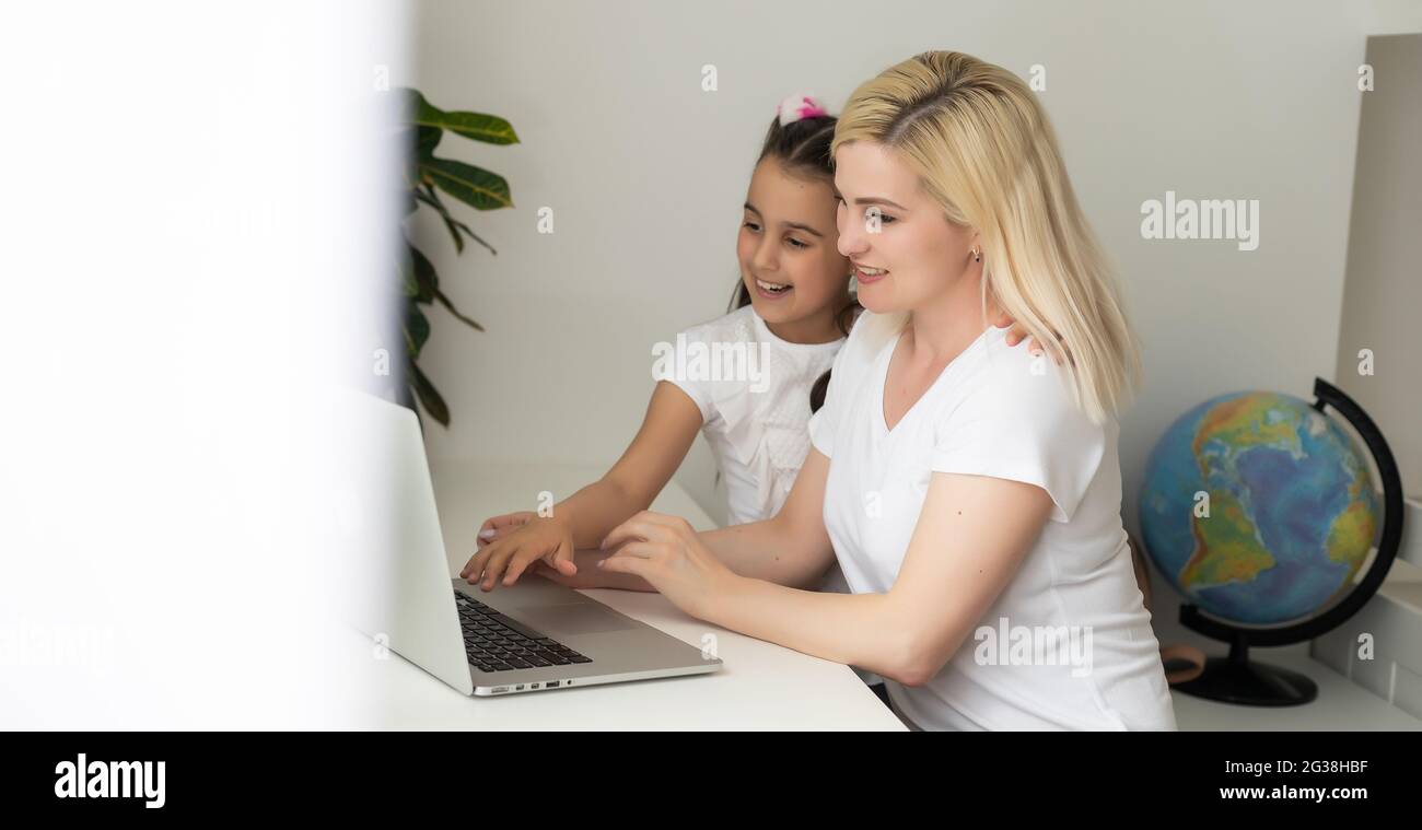 Online education of children. Mother and daughter of preschool watching ...