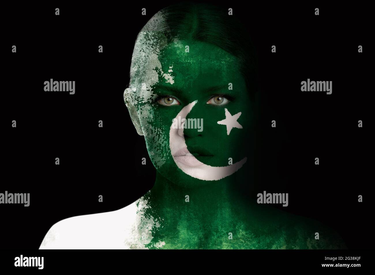 Young woman with face in colors of Pakistan flag on dark background ...